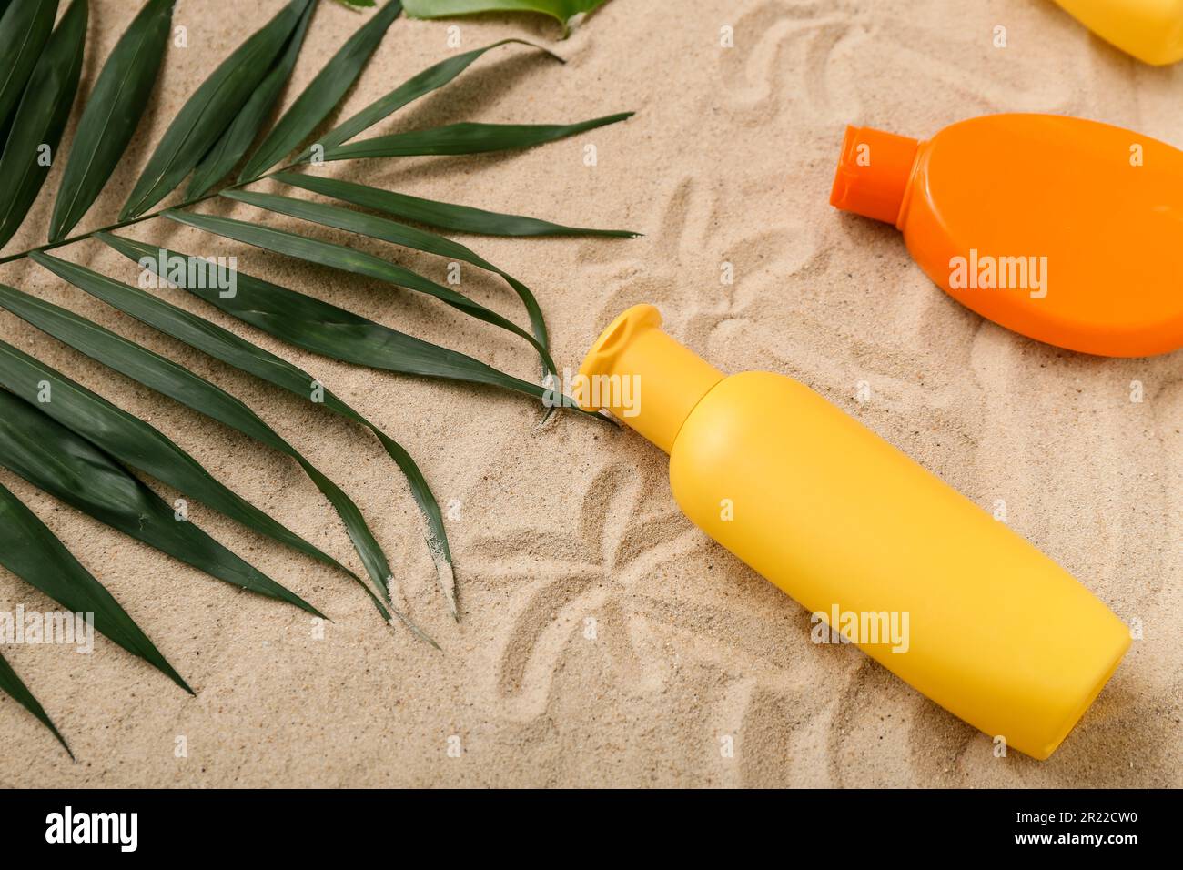 Creative composition with different sunscreen creams and palm leaves on ...