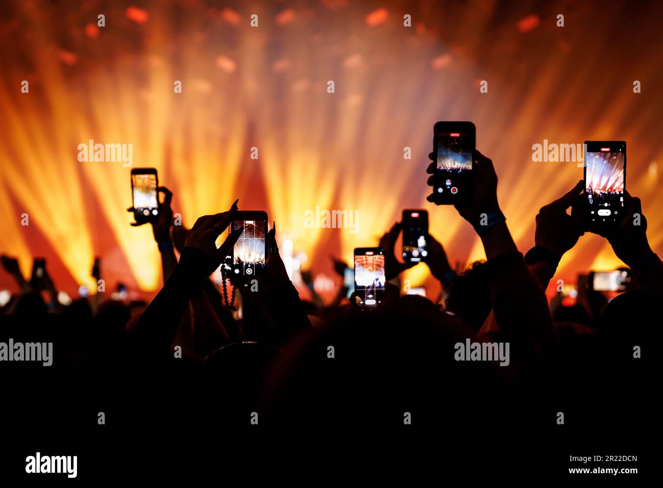 People at concert shooting video or photo using mobile phones Stock ...