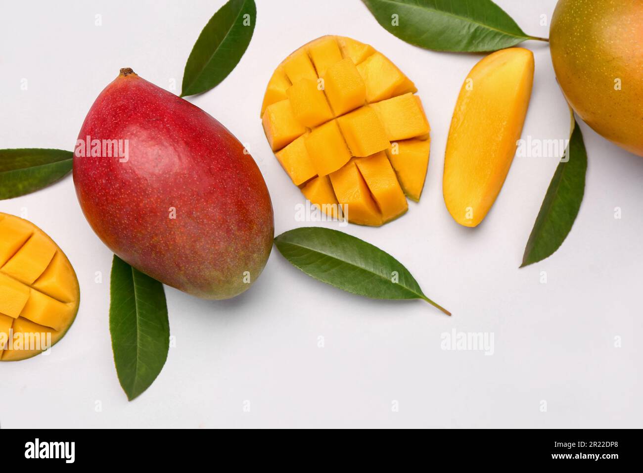 Fresh ripe mangoes on light background Stock Photo - Alamy