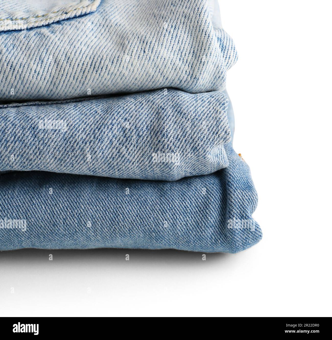 Different folded denim jeans on white background Stock Photo - Alamy