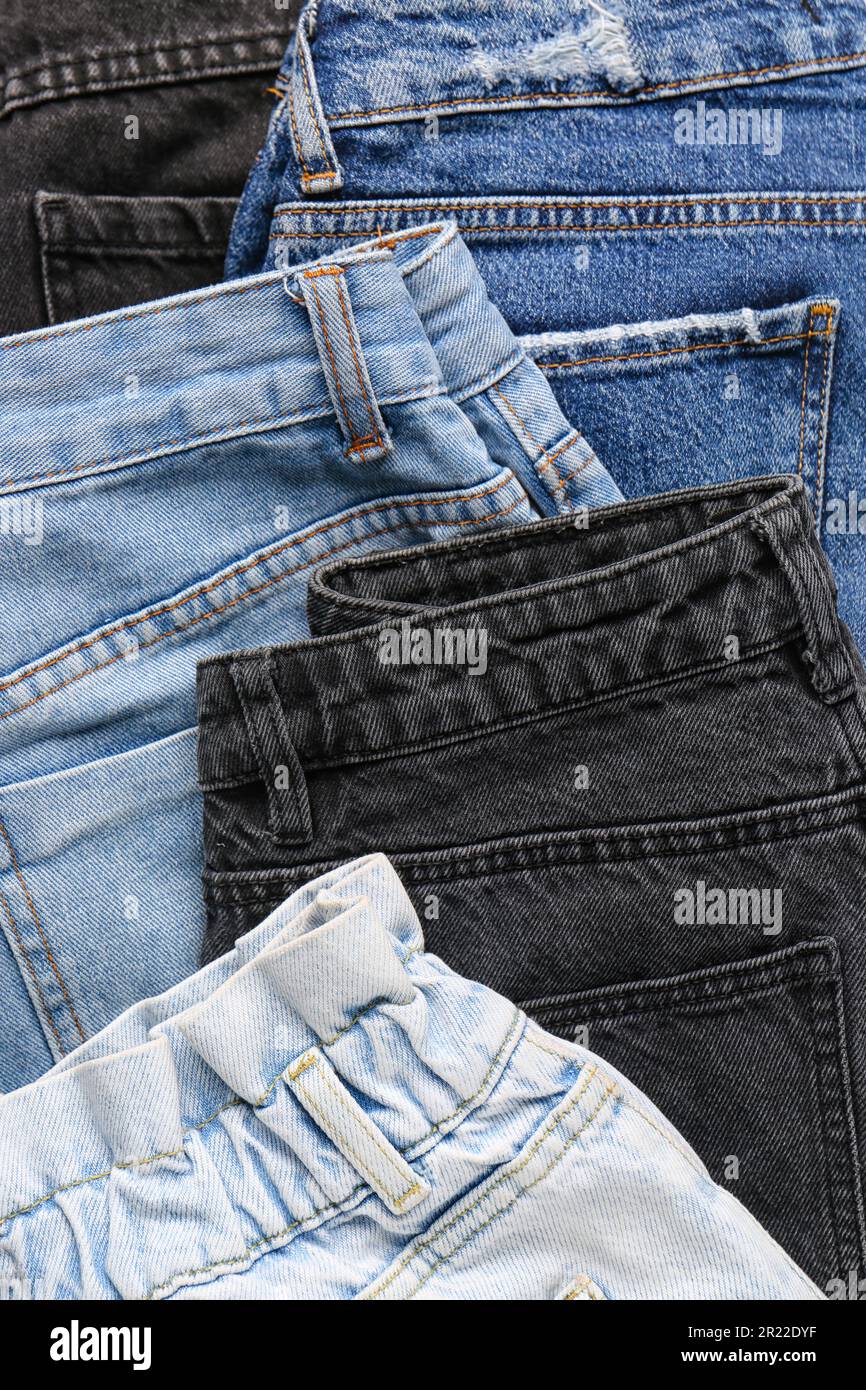 Different stylish denim jeans as background, closeup Stock Photo - Alamy