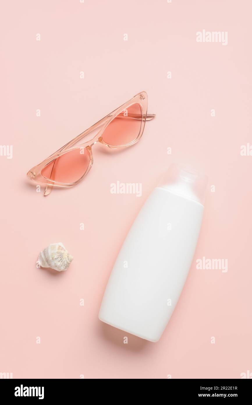 Bottle of sunscreen cream with sunglasses on pink background Stock ...
