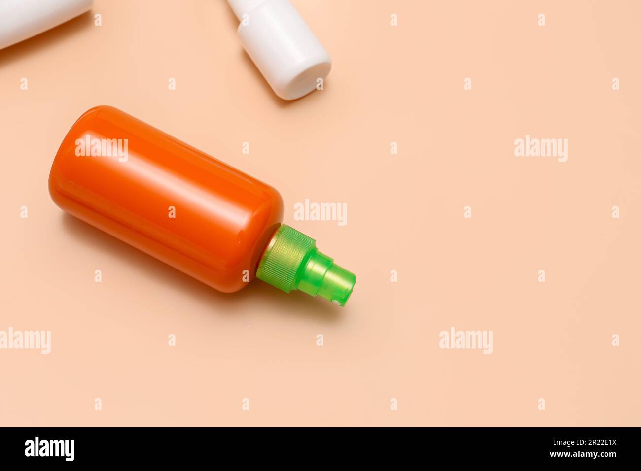 Different bottles of sunscreen cream on pale orange background Stock ...