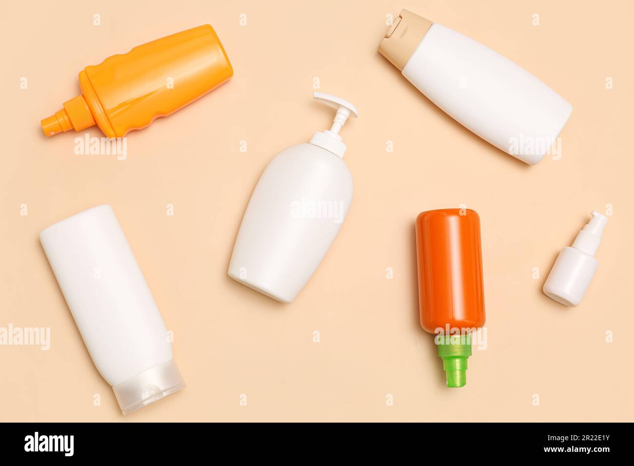 Different bottles of sunscreen cream on pale orange background Stock ...