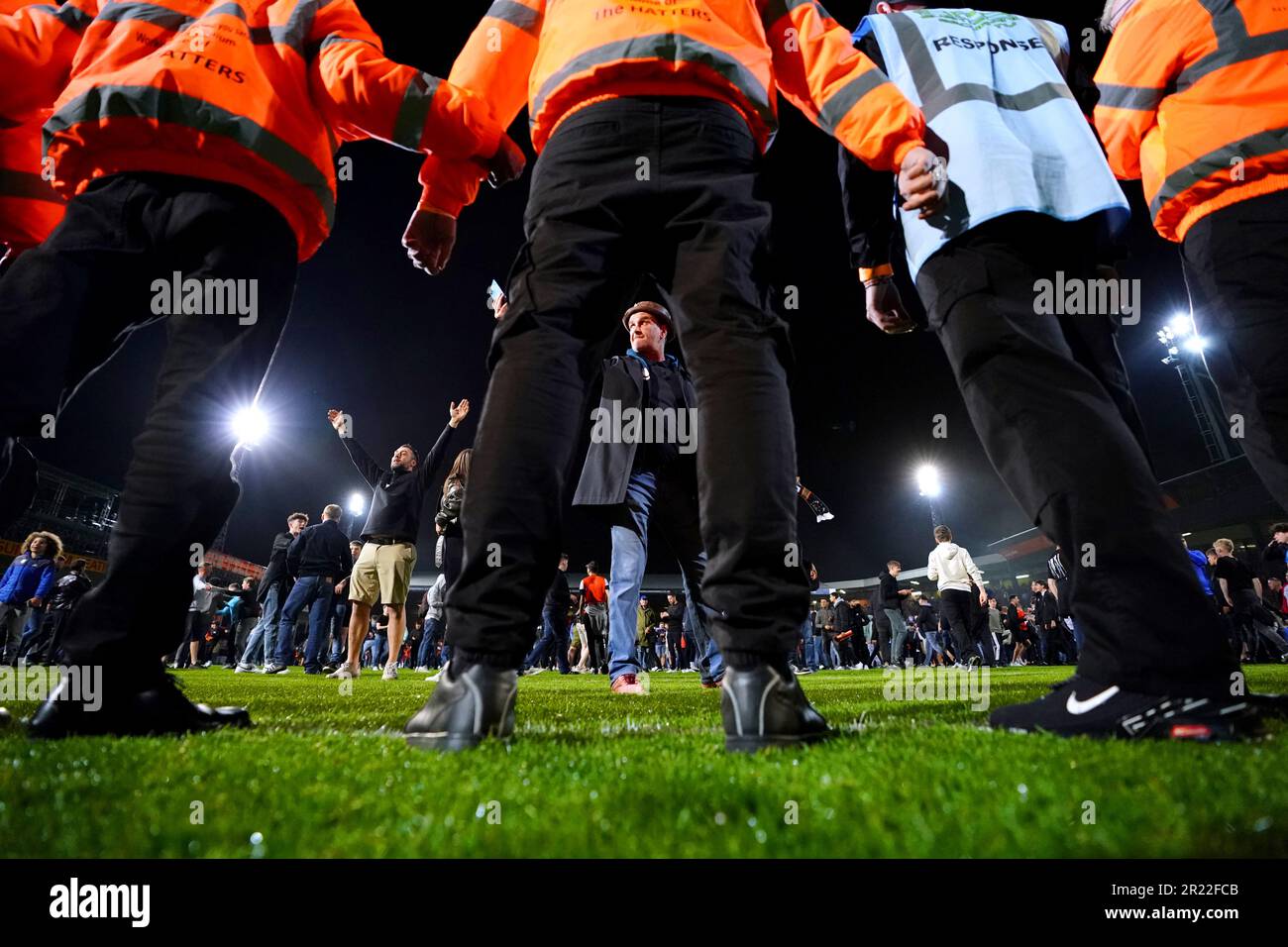 Stewards and police control the crowd as Luton Town fans celebrate on ...