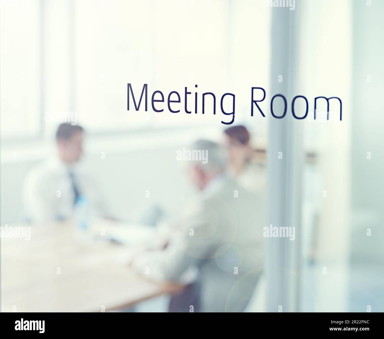 The meeting is in session. Closeup of a glass door reading meeting room ...