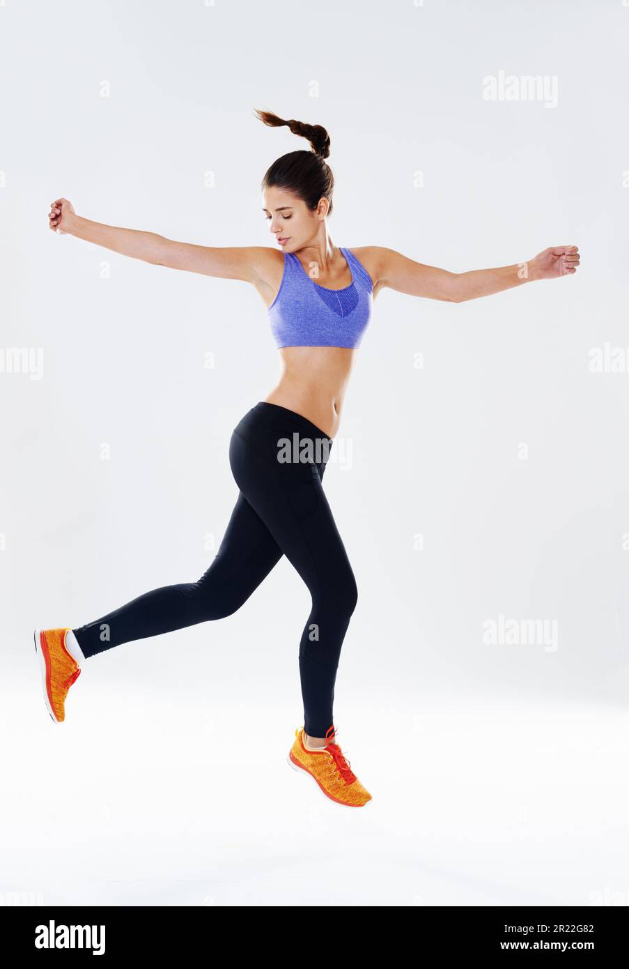 Fitness can be fun. an attractive young woman doing an aerobic dance ...