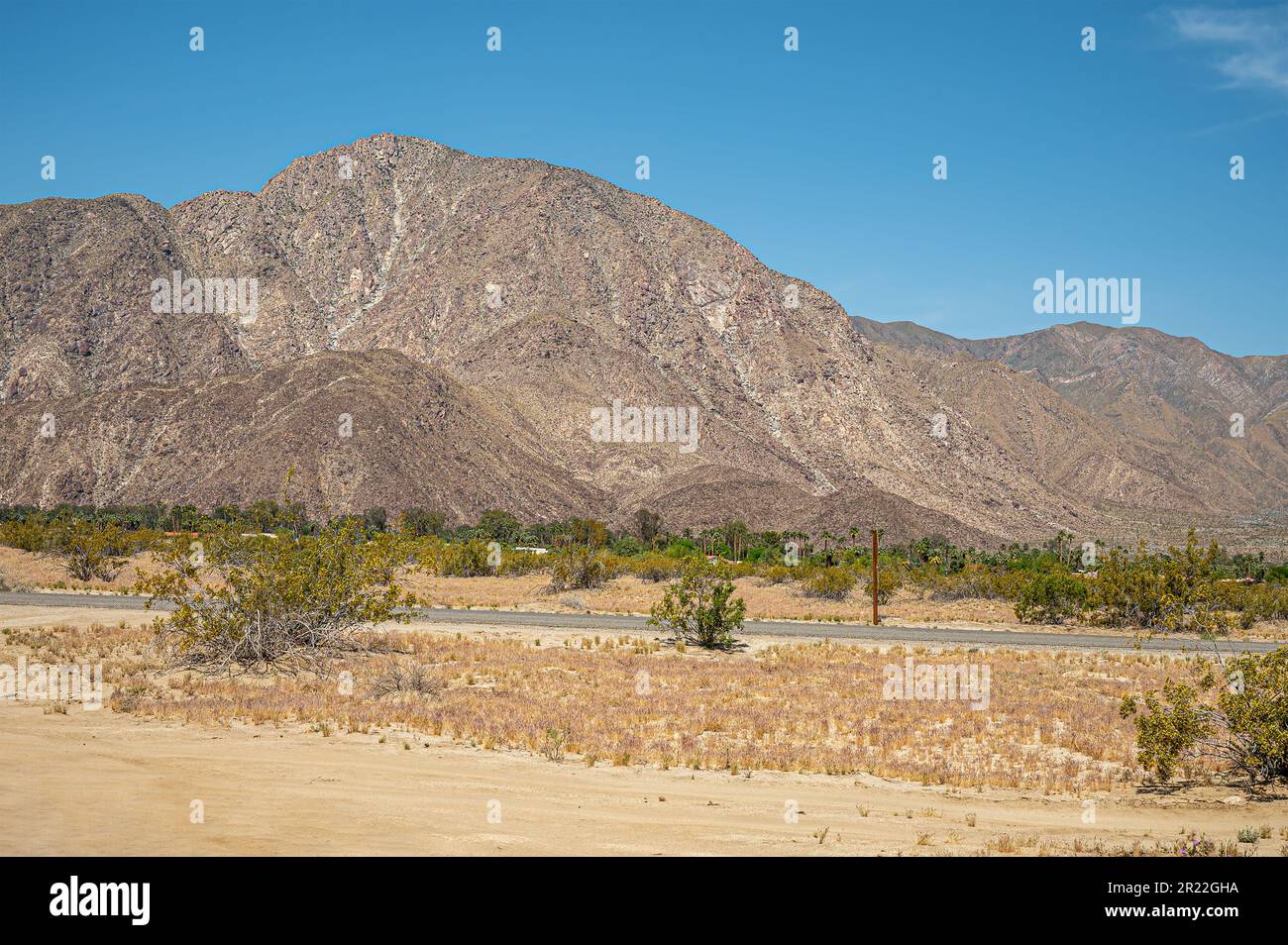 Borrego Springs, CA, USA - April 24, 2023: Asphalt road through wide ... Borrego Springs, CA, USA - April 24, 2023: Asphalt road through wide ...