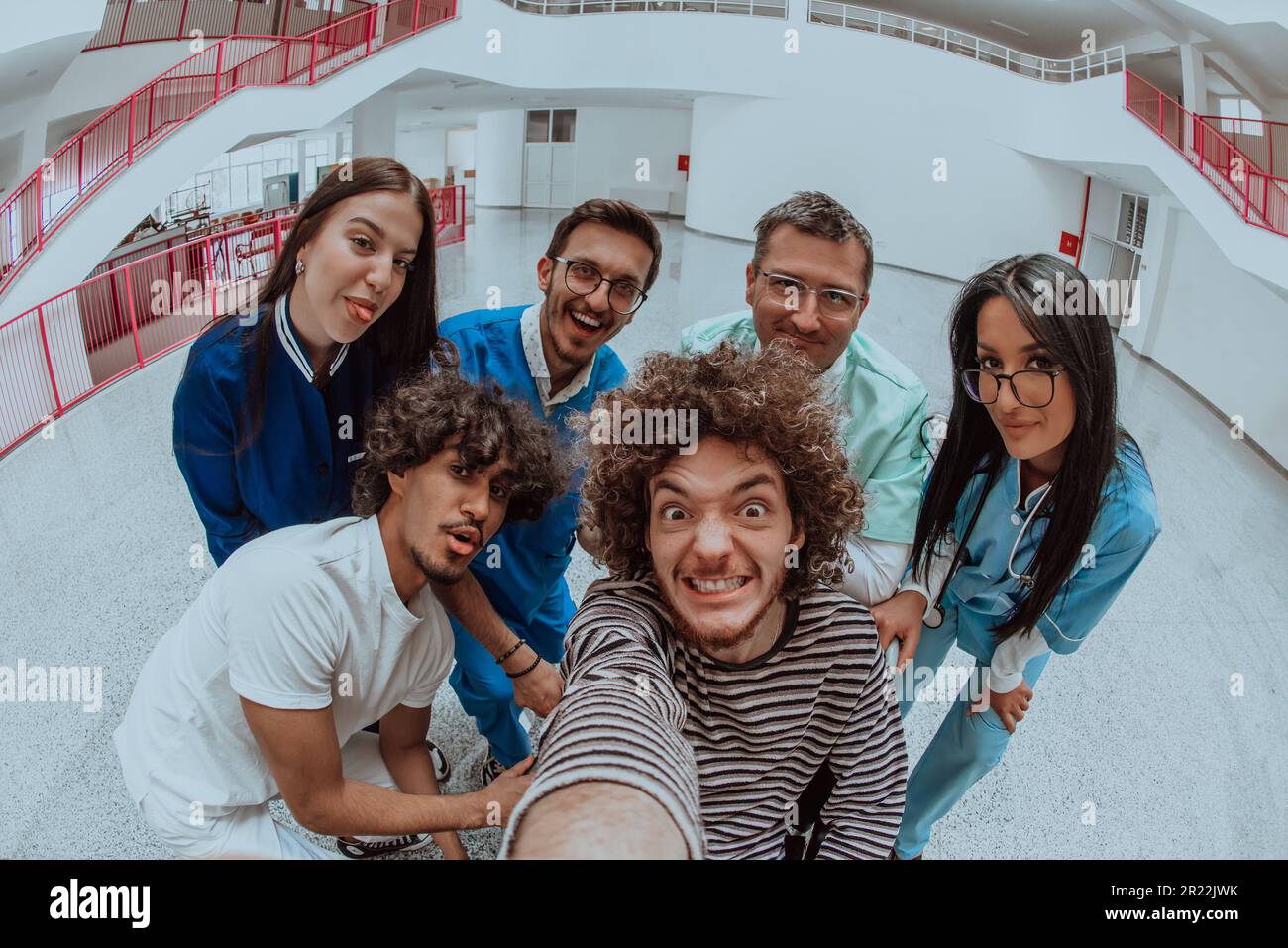 In a modern hospital hallway, a doctor and a medical nurse capture a ...
