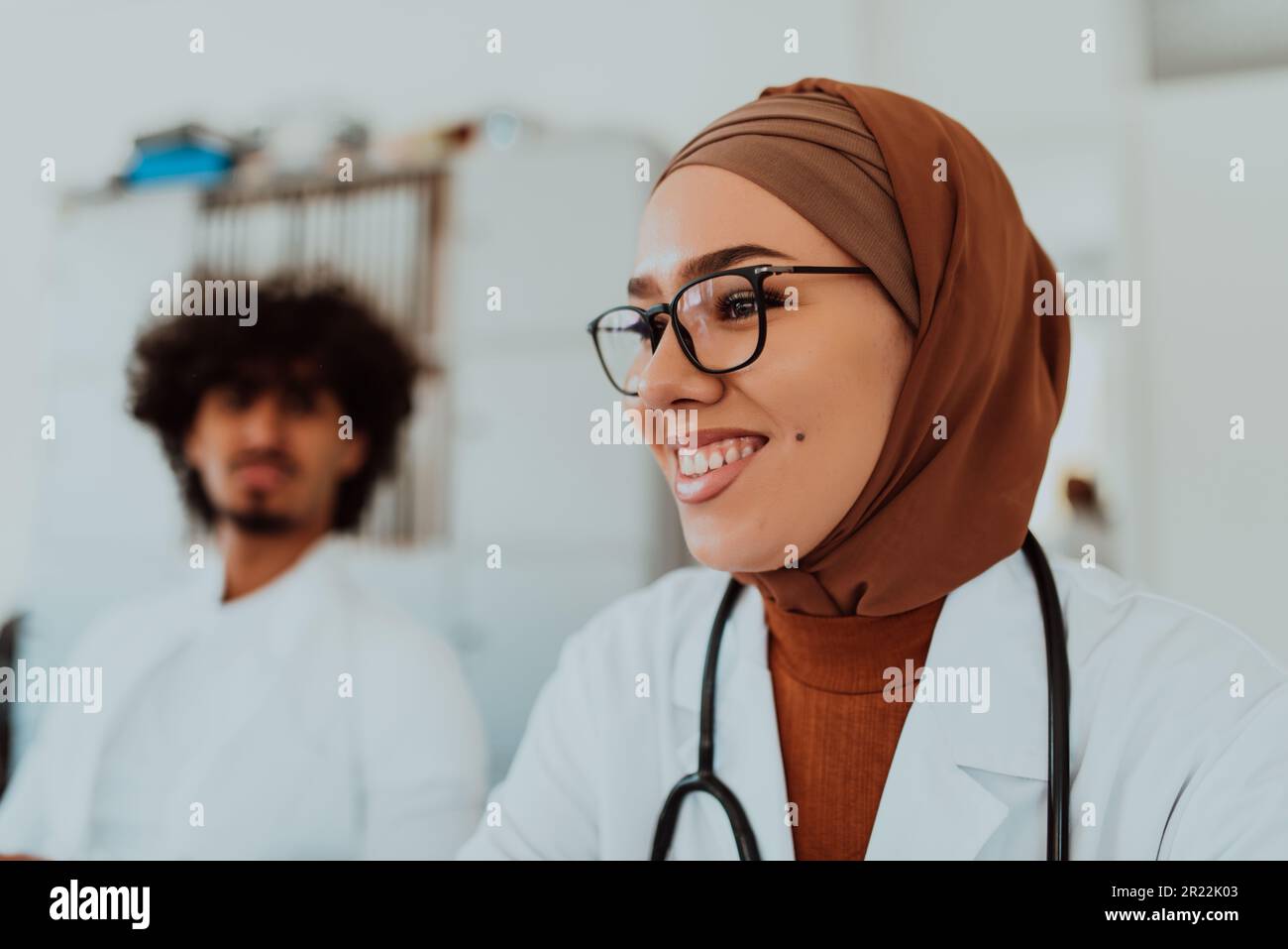 In a modern meeting room, a Muslim female doctor wearing a hijab ...