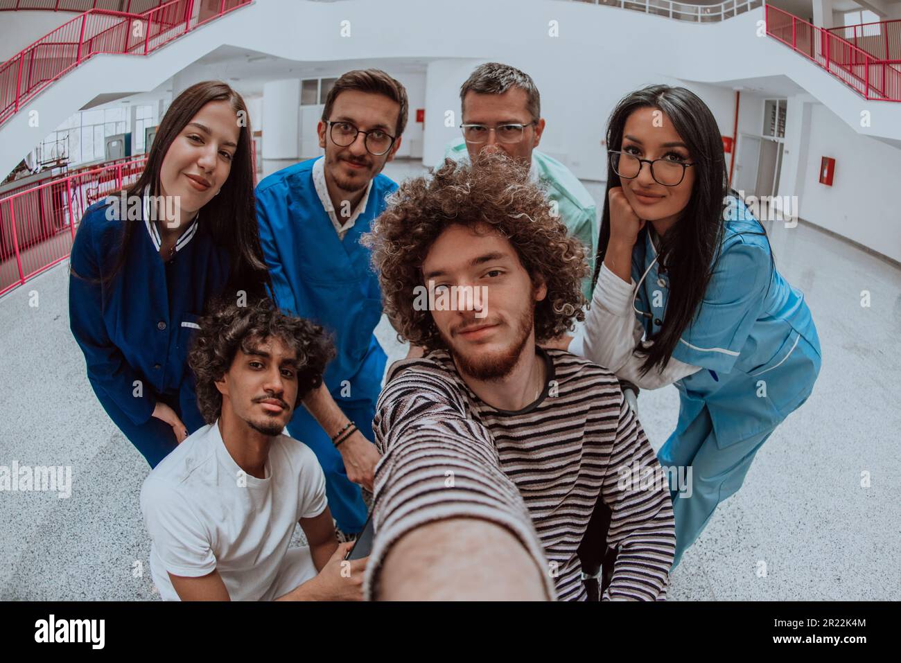 In a modern hospital hallway, a doctor and a medical nurse capture a ...