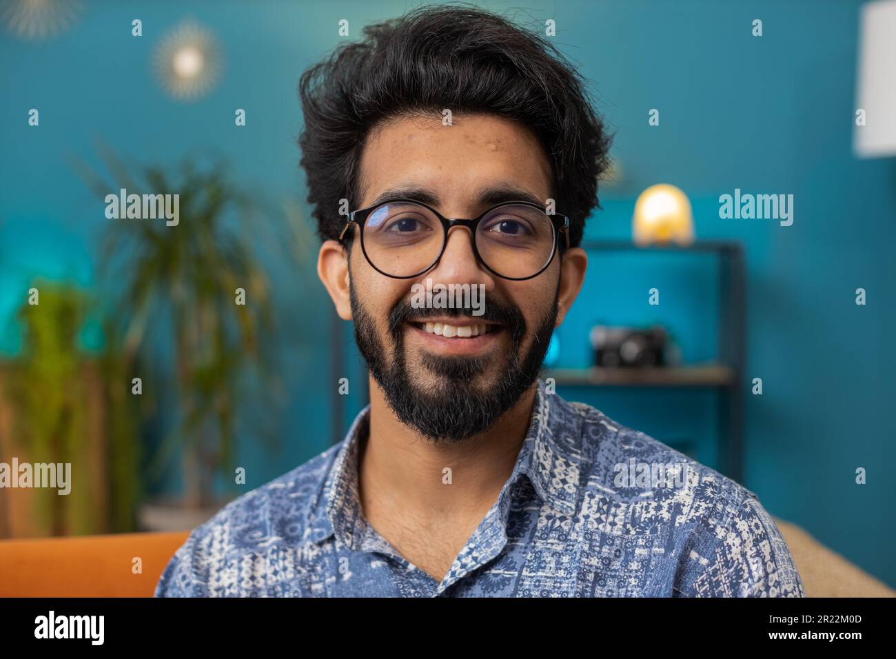 Portrait of happy calm indian man at home couch smiling friendly, glad ...