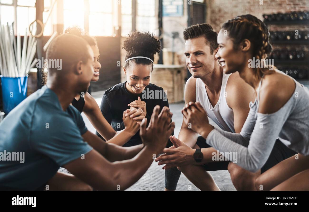 An exercise staple, the classic squat. a group of young people doing ...