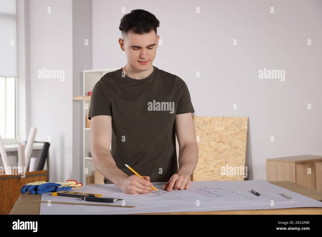Young man working blueprints home hi-res stock photography and images ...
