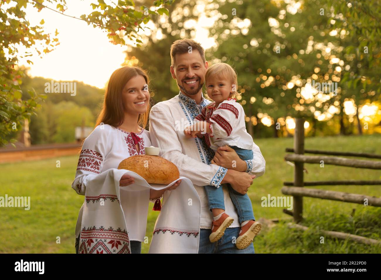 Happy cute family in embroidered Ukrainian shirts with korovai bread on ...