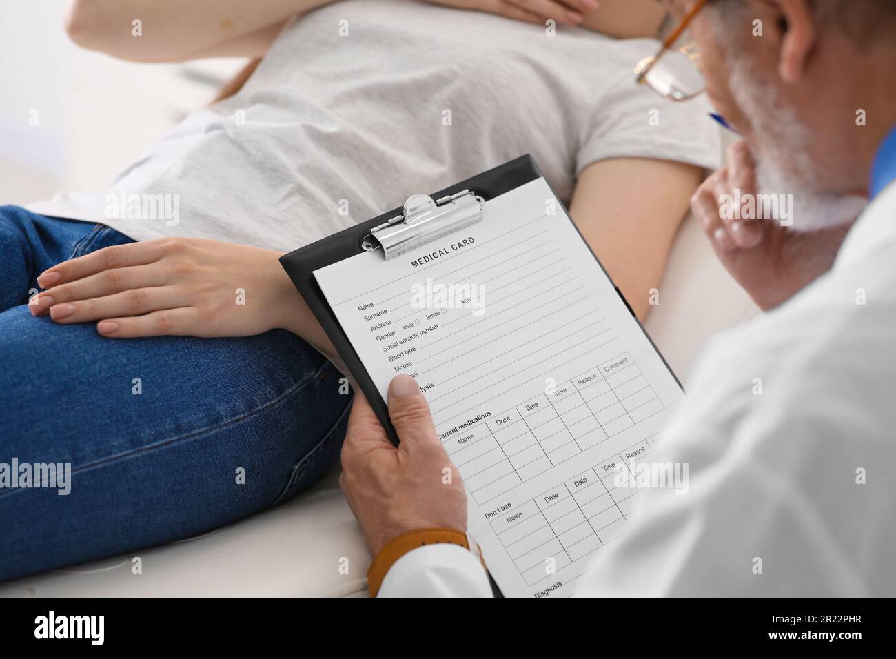 Doctor filling form senior woman hi-res stock photography and images ...