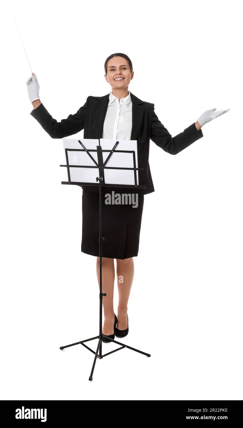 Happy young conductor with baton and note stand on white background ...