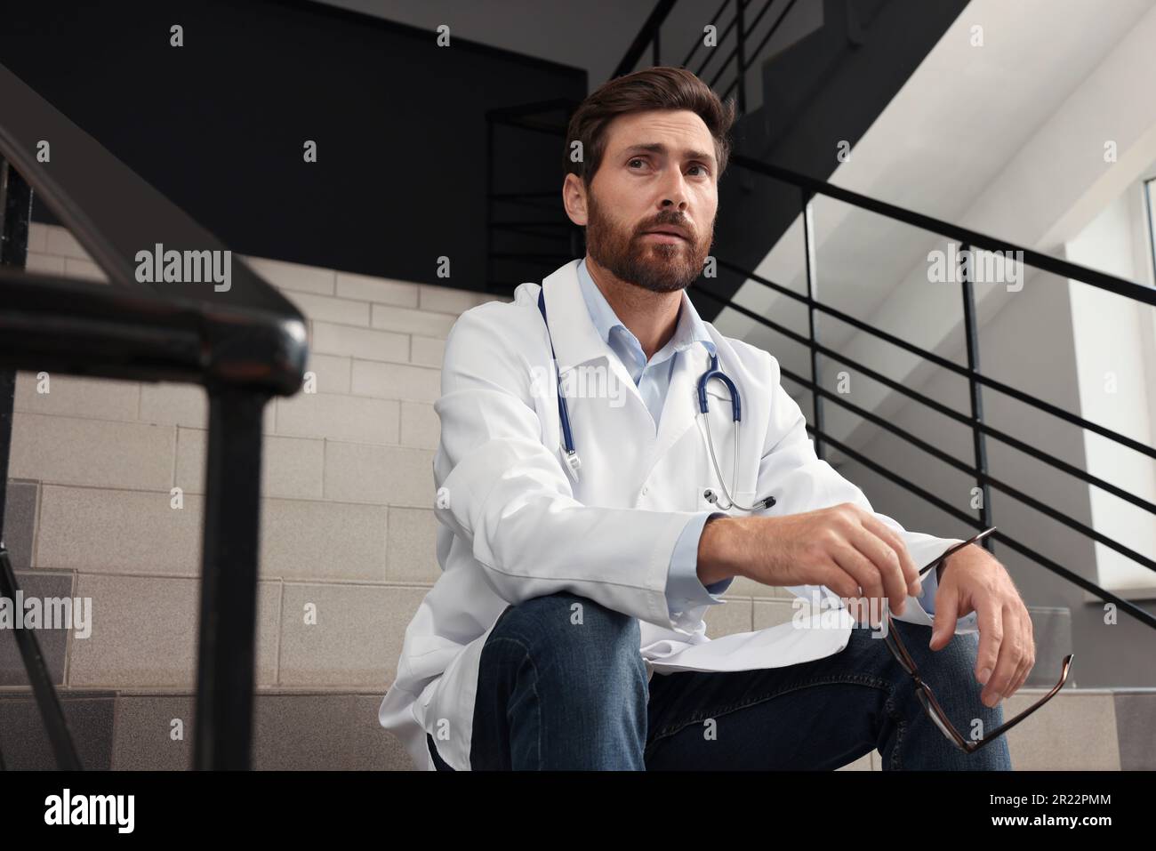 Bearded caucasian doctor sitting hi-res stock photography and images ...