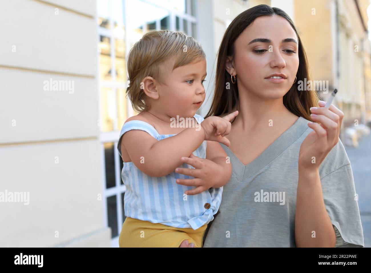 Mother with cigarette and child outdoors. Don't smoke near kids Stock ...