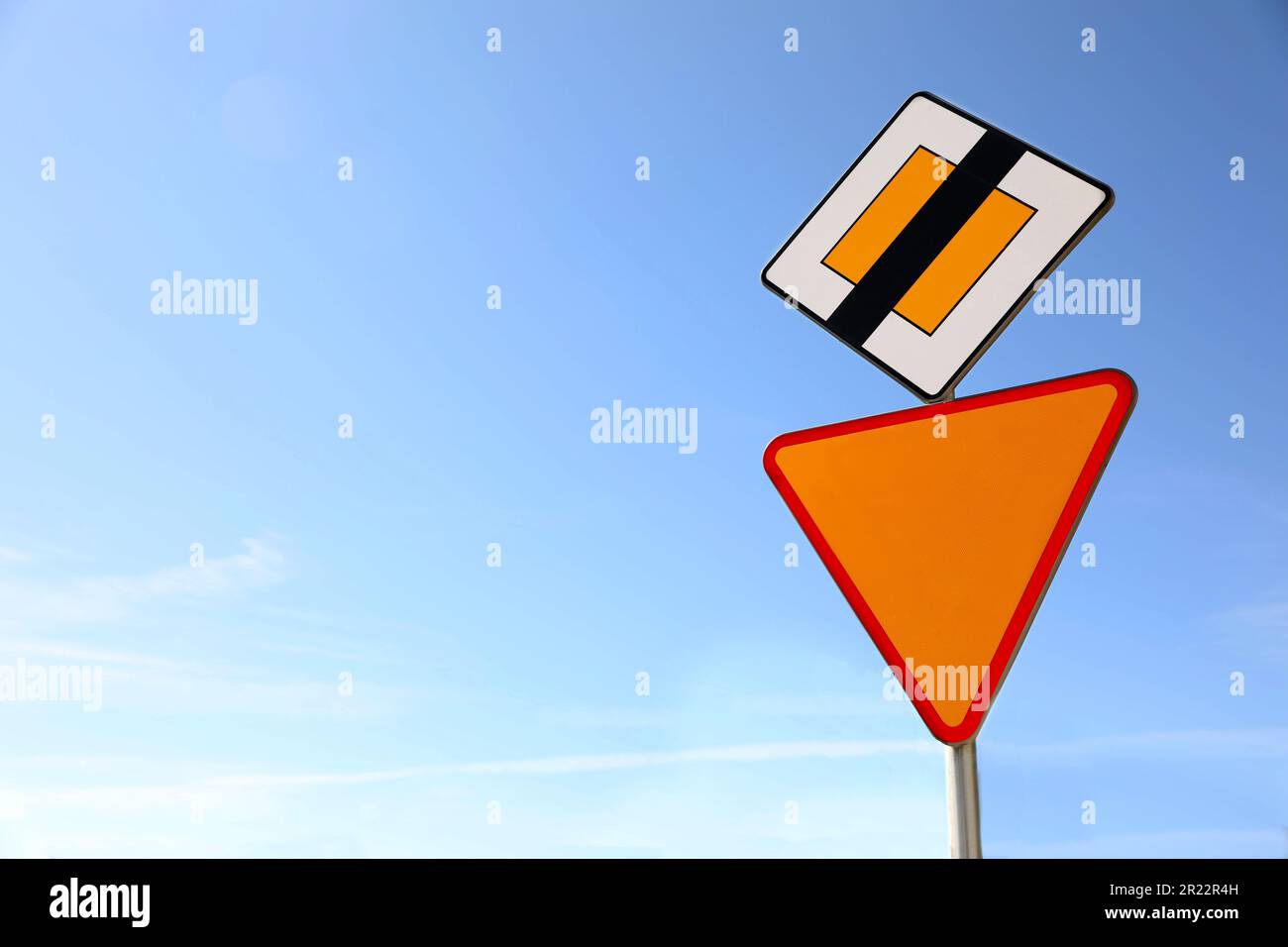 Different road signs against blue sky. Space for text Stock Photo - Alamy