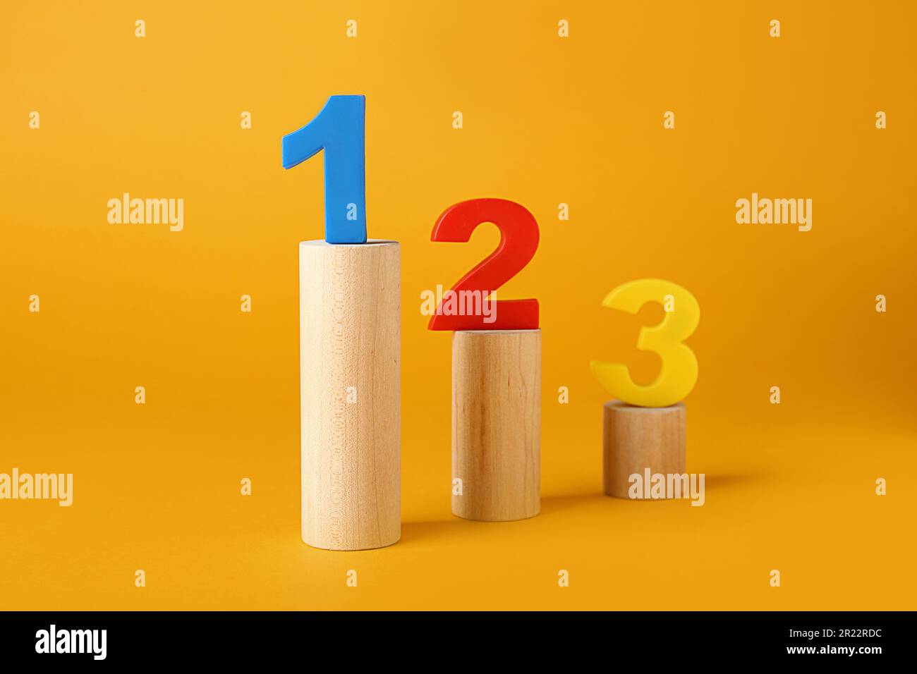 Numbers on wooden blocks against pale orange background. Competition ...