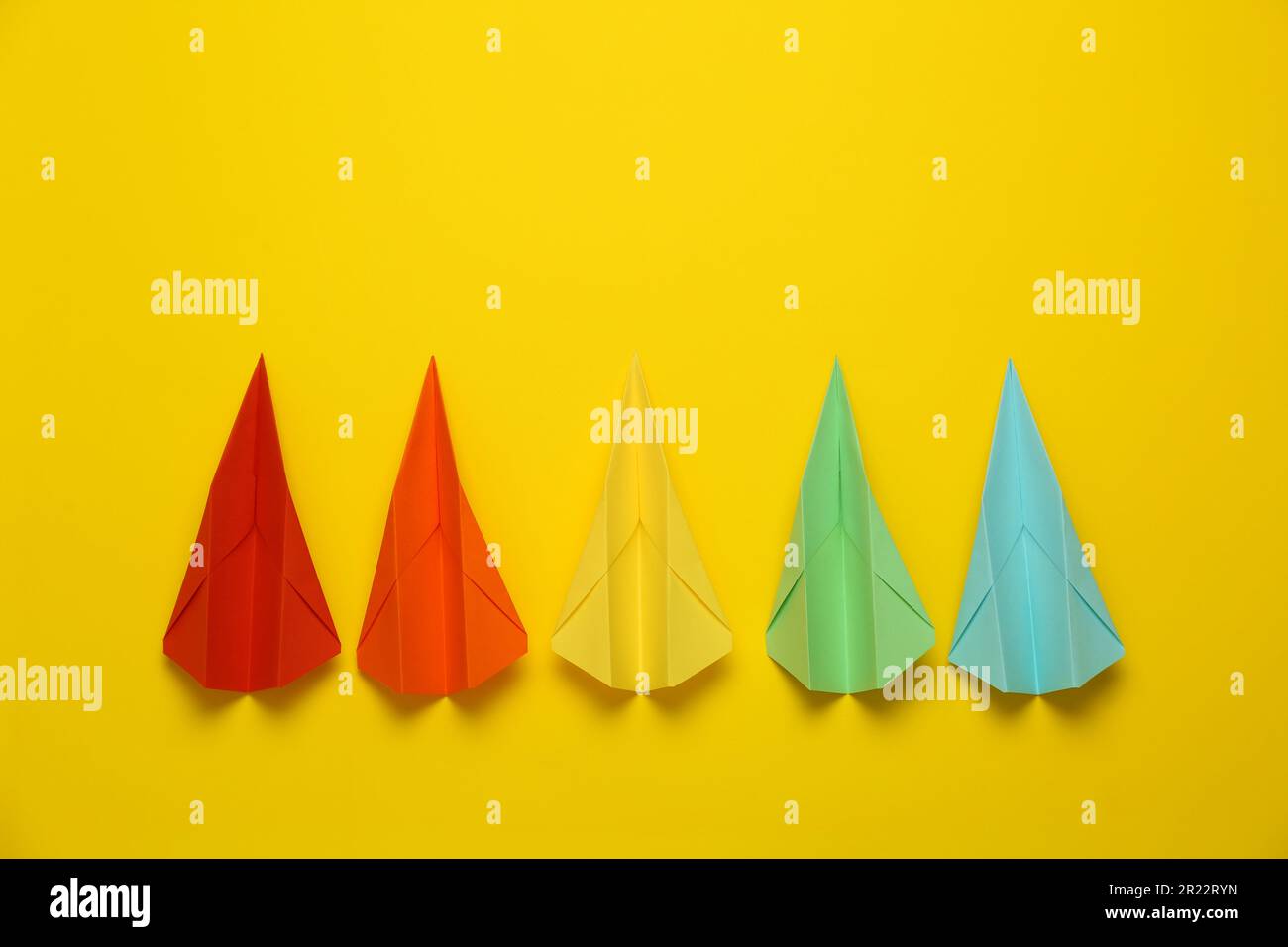Different handmade paper planes on yellow background, flat lay. Space ...