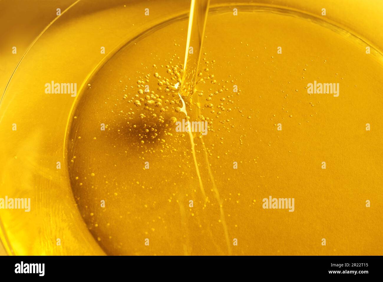 Pouring cooking oil into bowl, closeup view Stock Photo - Alamy