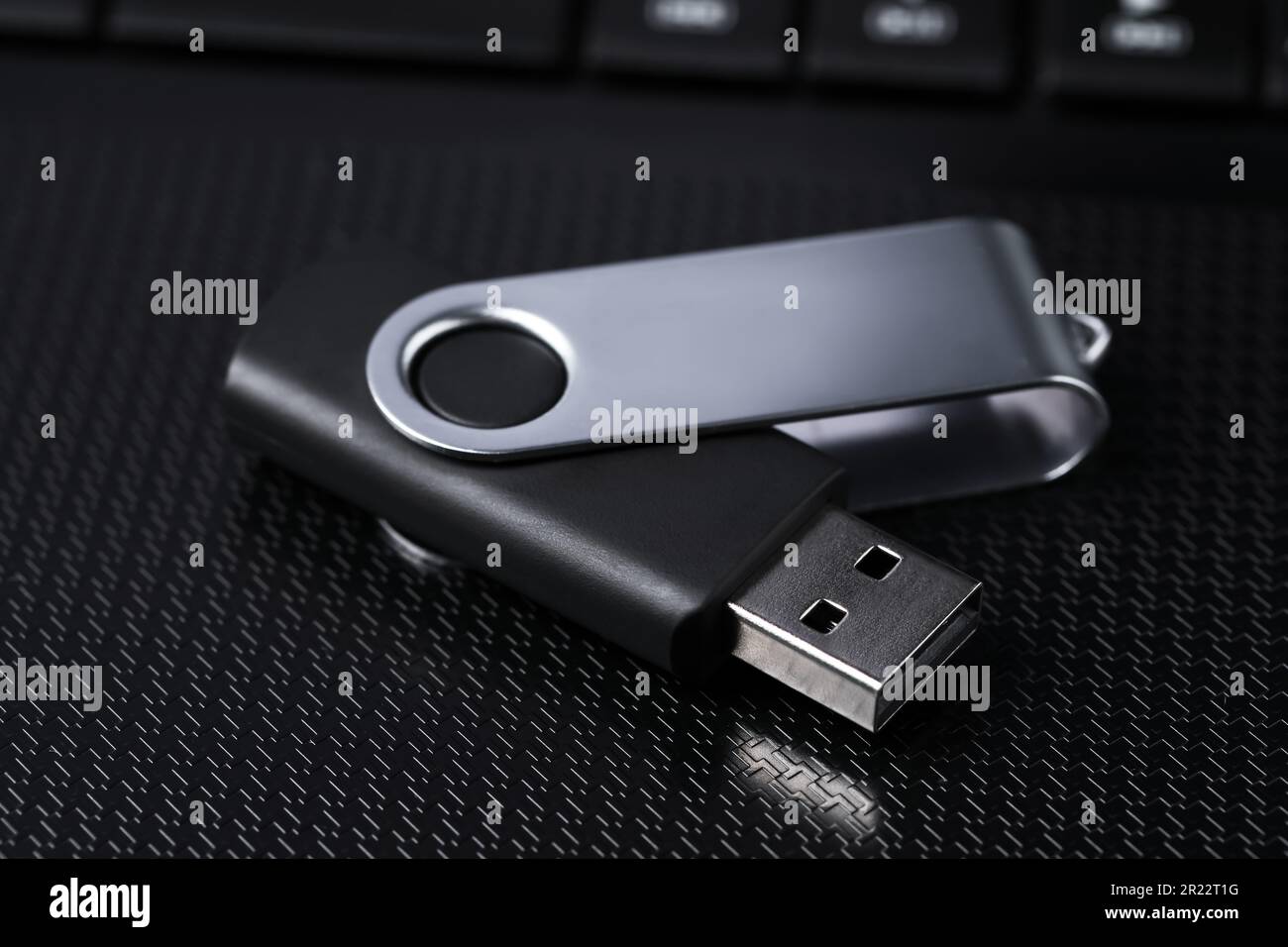 Modern usb flash drive on laptop, closeup Stock Photo - Alamy