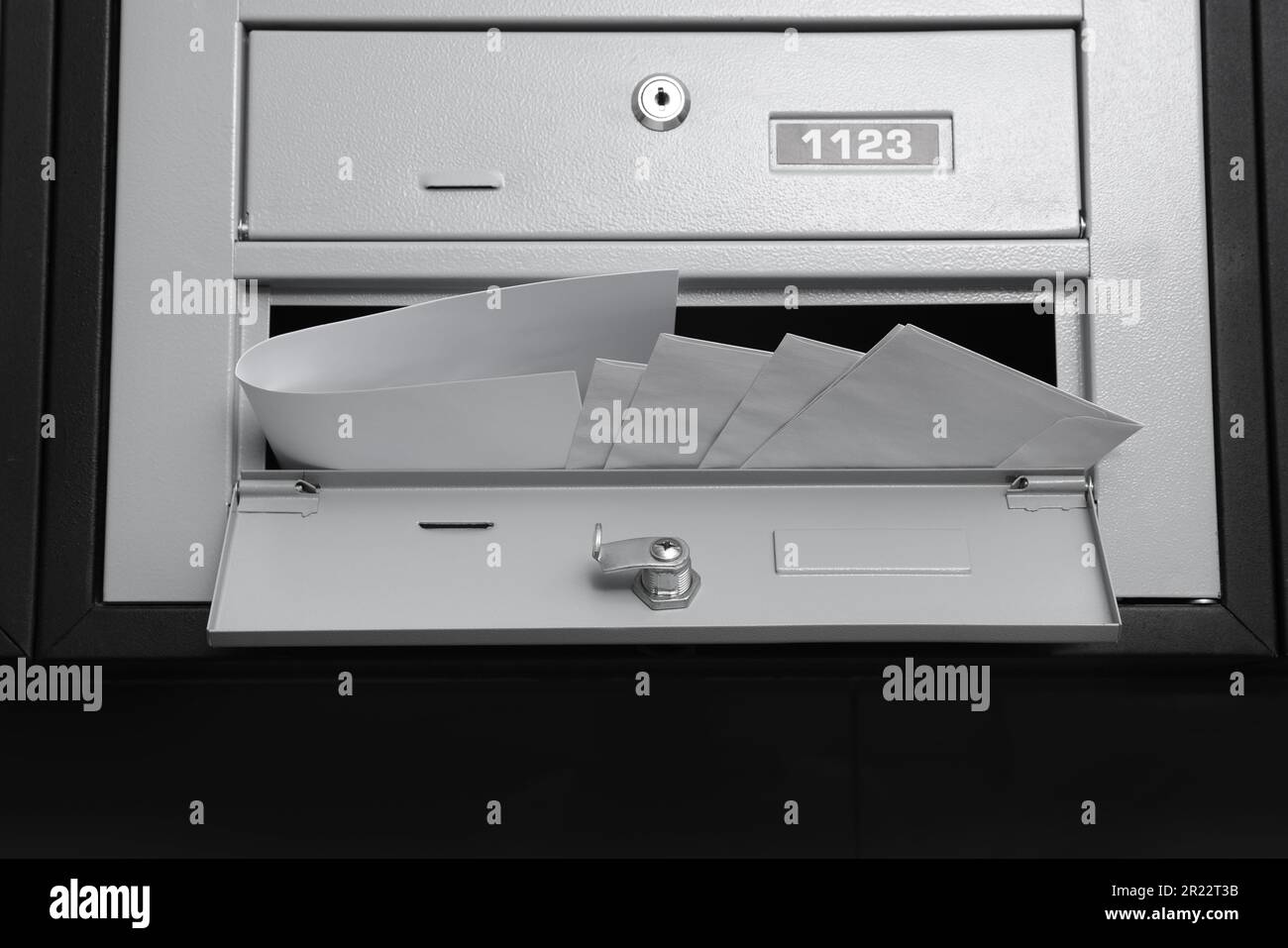 Open grey metal mailbox with envelopes indoors Stock Photo - Alamy