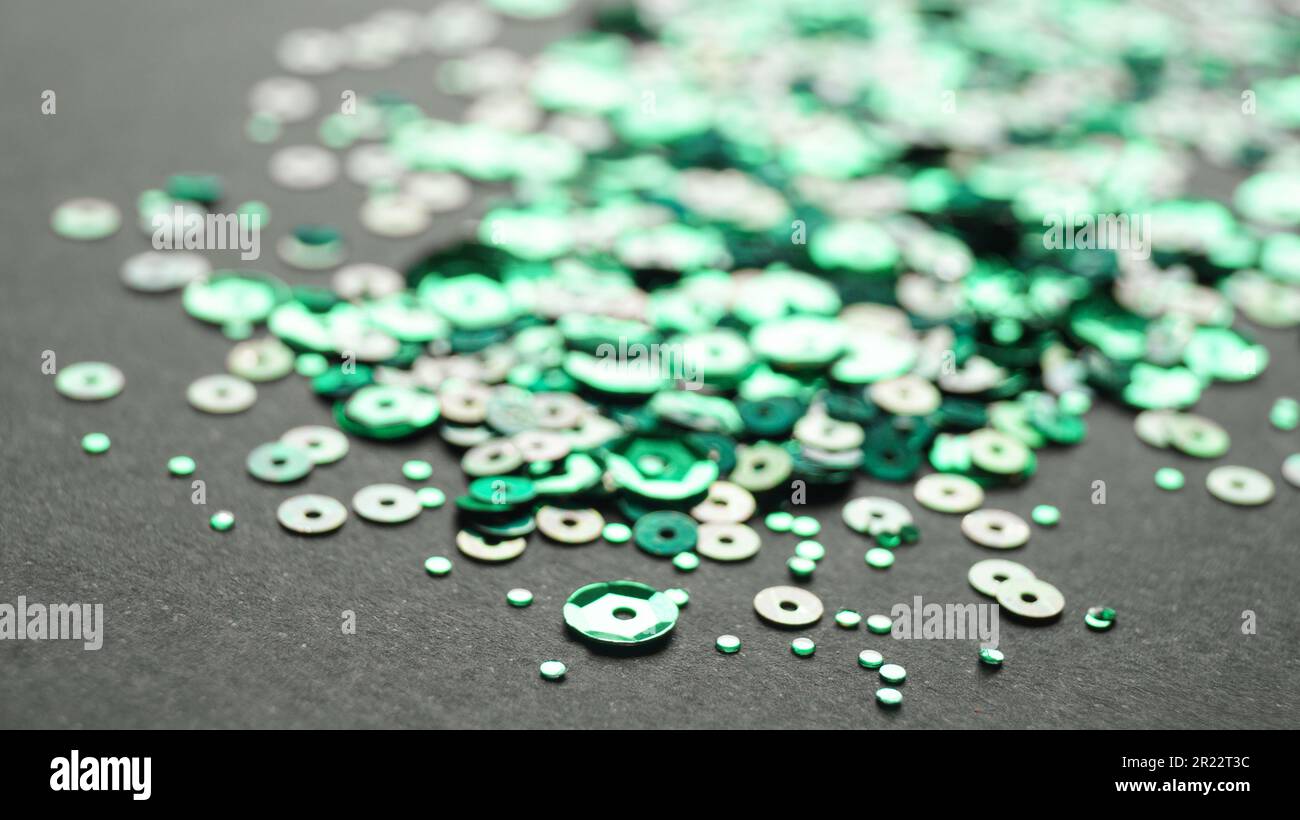 Pile of beautiful green sequins on black background, closeup Stock ...