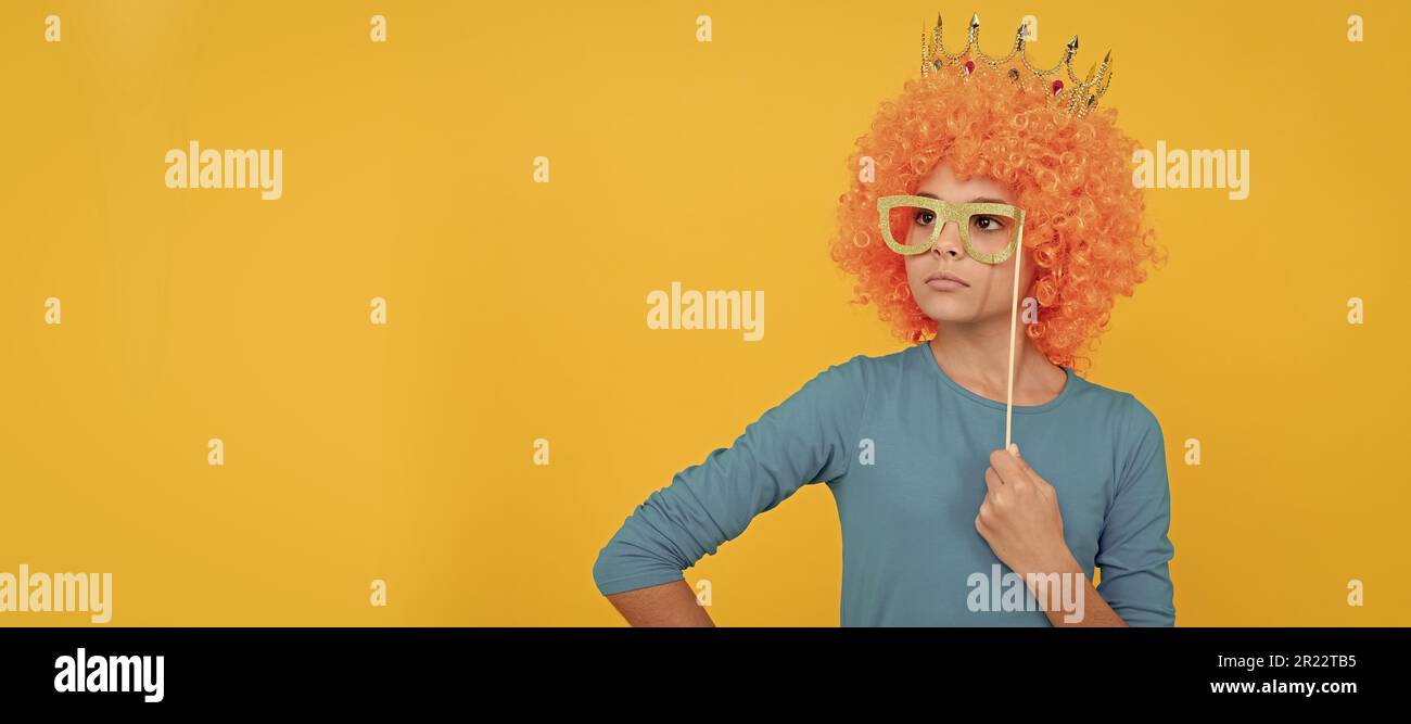 serious teen girl in fancy clown wig wear queen crown and funny party ...