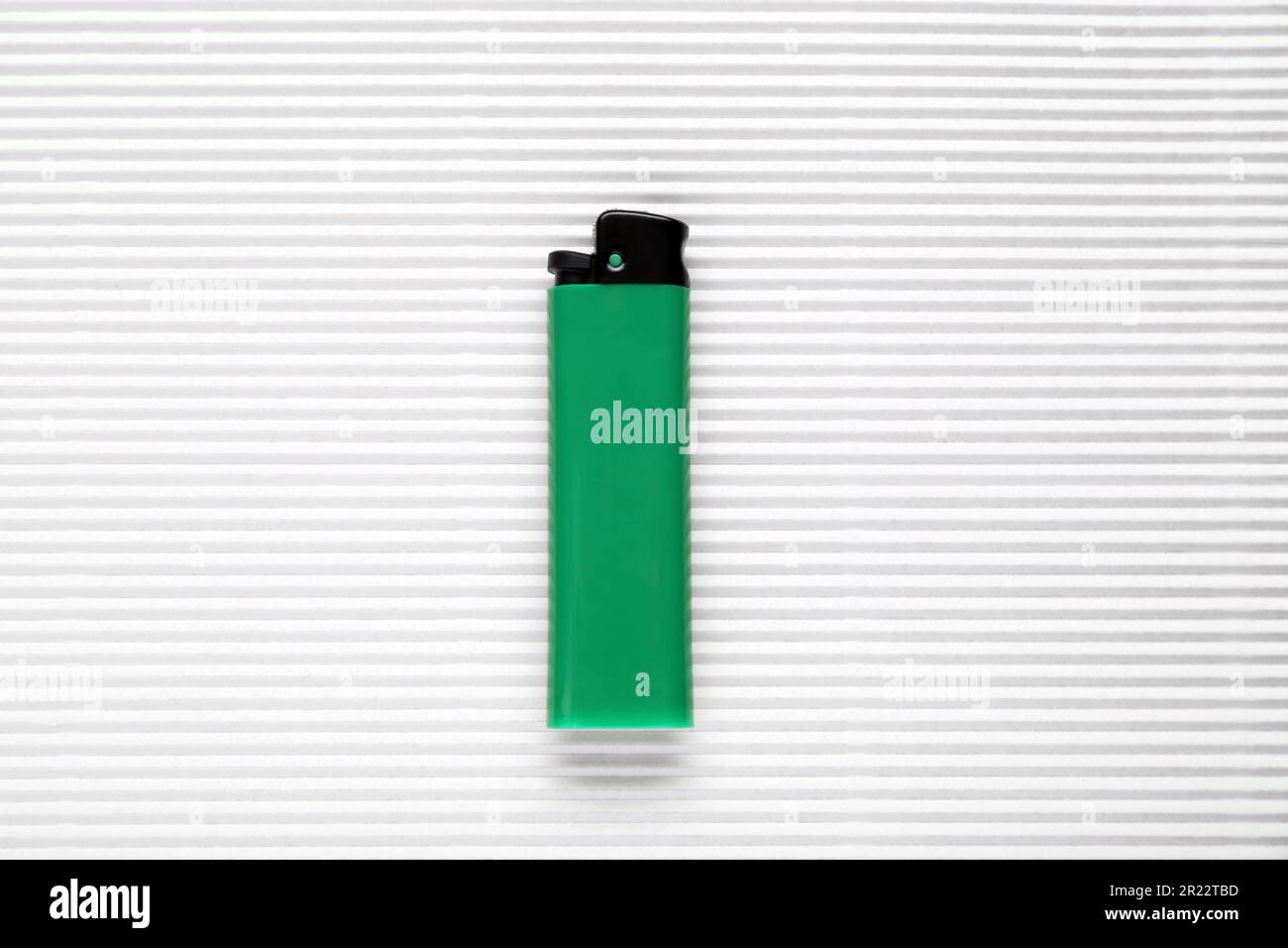 Stylish small pocket lighter on white corrugated fiberboard, top view ...