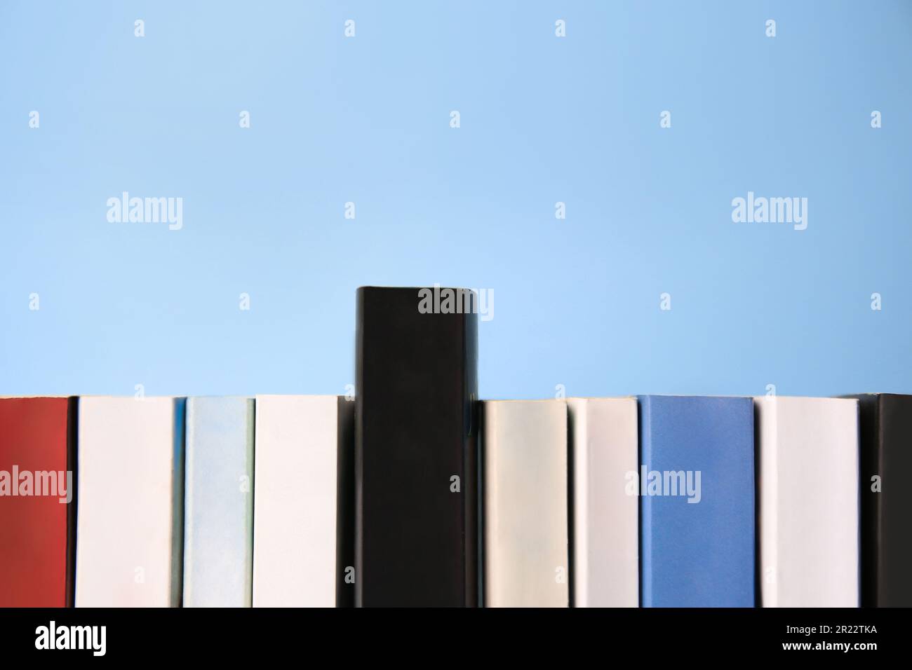 Collection of books on light blue background, space for text Stock ...