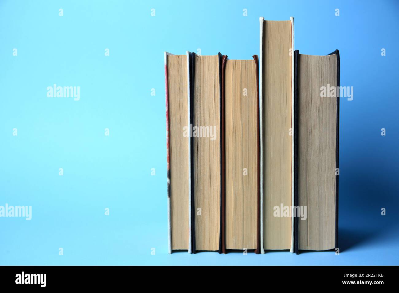 Collection of books on light blue background, space for text Stock ...