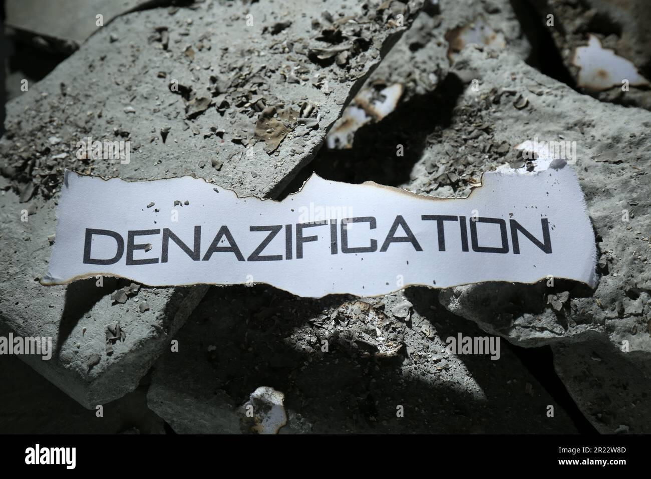 Paper with word Denazification on pieces of concrete, closeup Stock ...