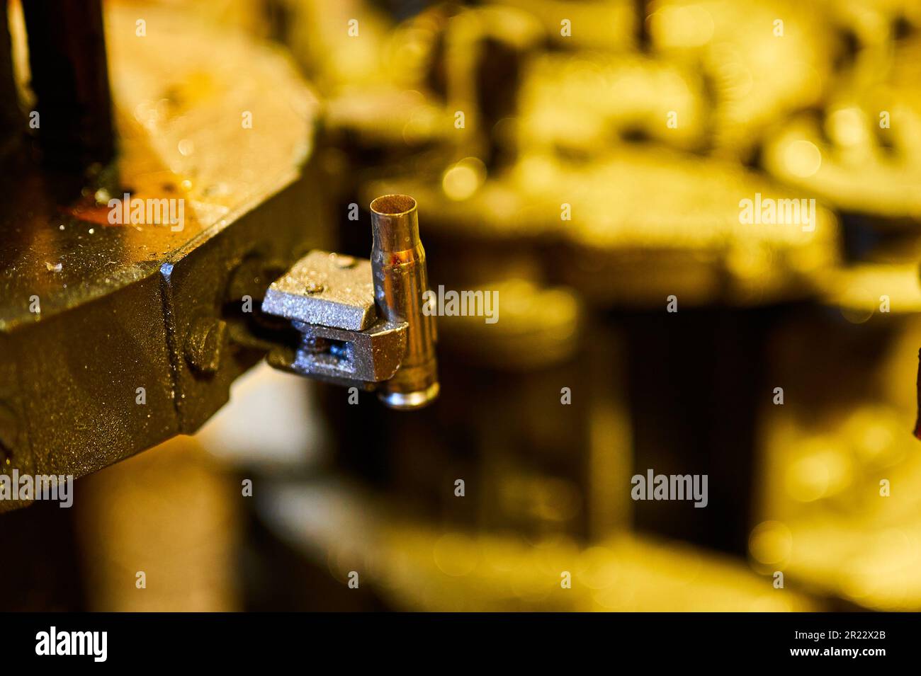 Clamp with brass bullet casing at ammo production plant Stock Photo - Alamy
