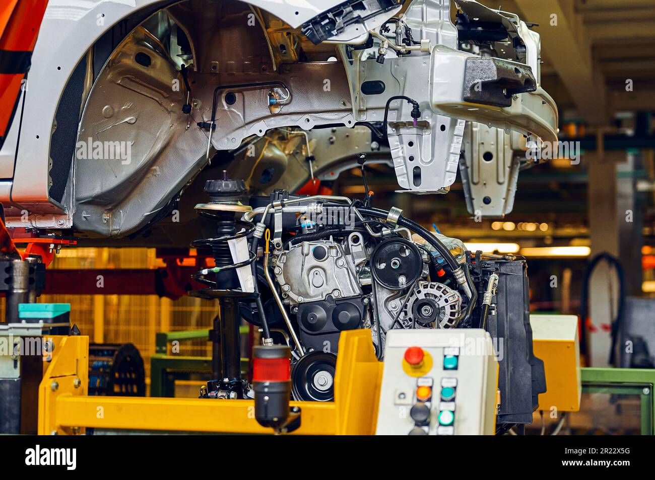 Installing of motor into automobile room in workshop Stock Photo - Alamy