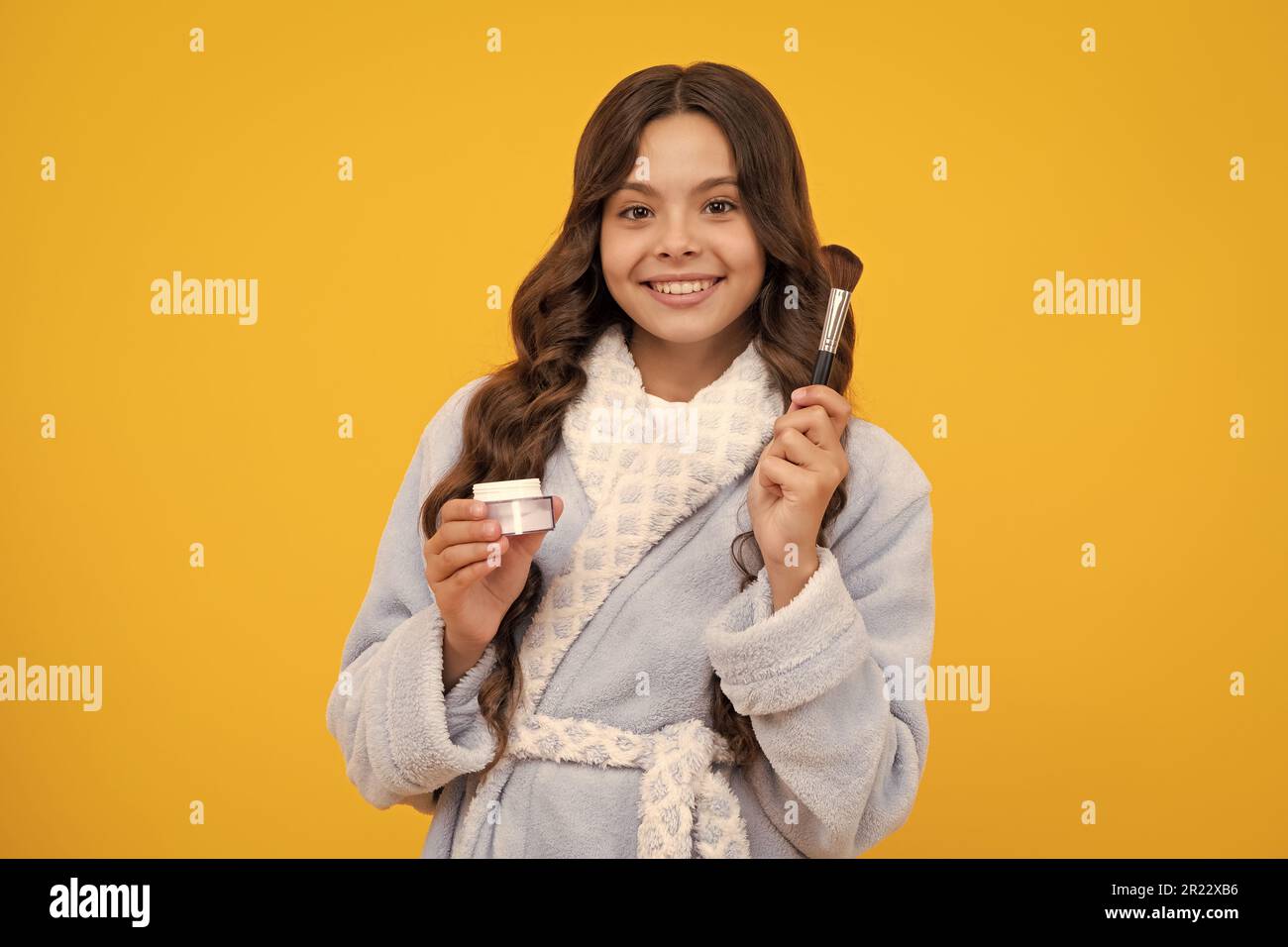 Kids make up products. Makeup teen child artist apply face powder with ...