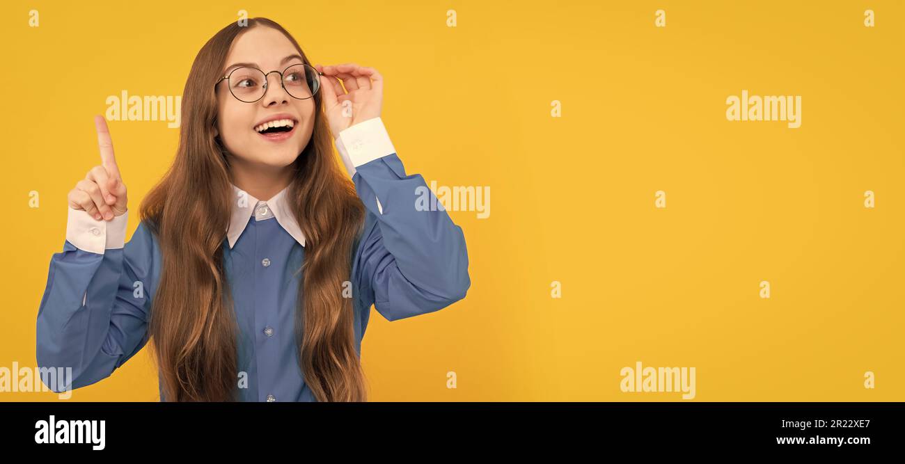 Clever idea. Clever girl in eyeglasses yellow background. School age ...