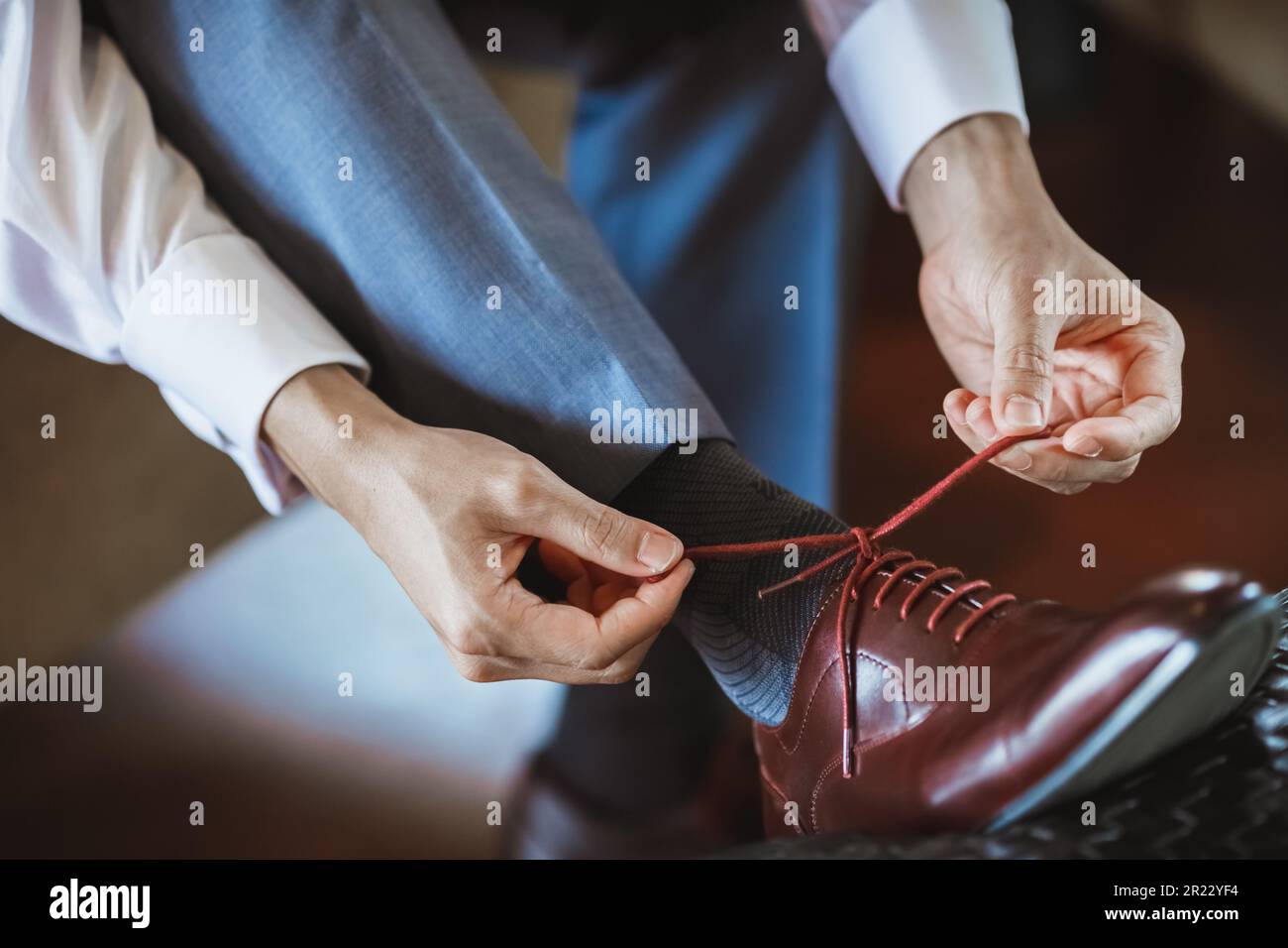 Handsome men tying their stylish shoe laces. The appearance of a ...