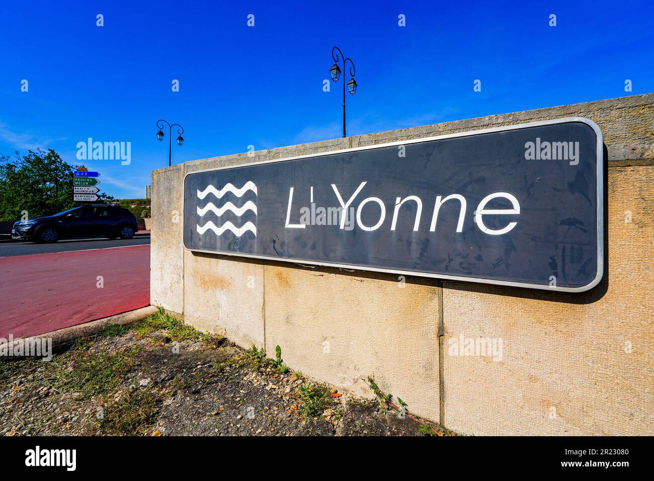 Black road sign announcing the crossing of the Yonne river in the town ...