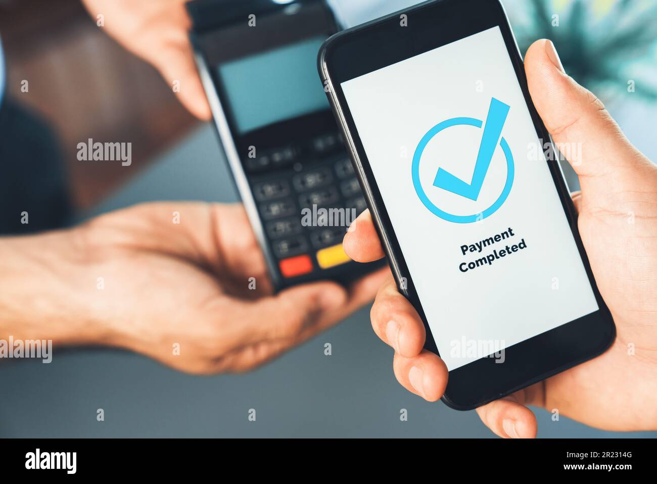 Hand holding smartphone with NFC QR code device, scanning contactless ...