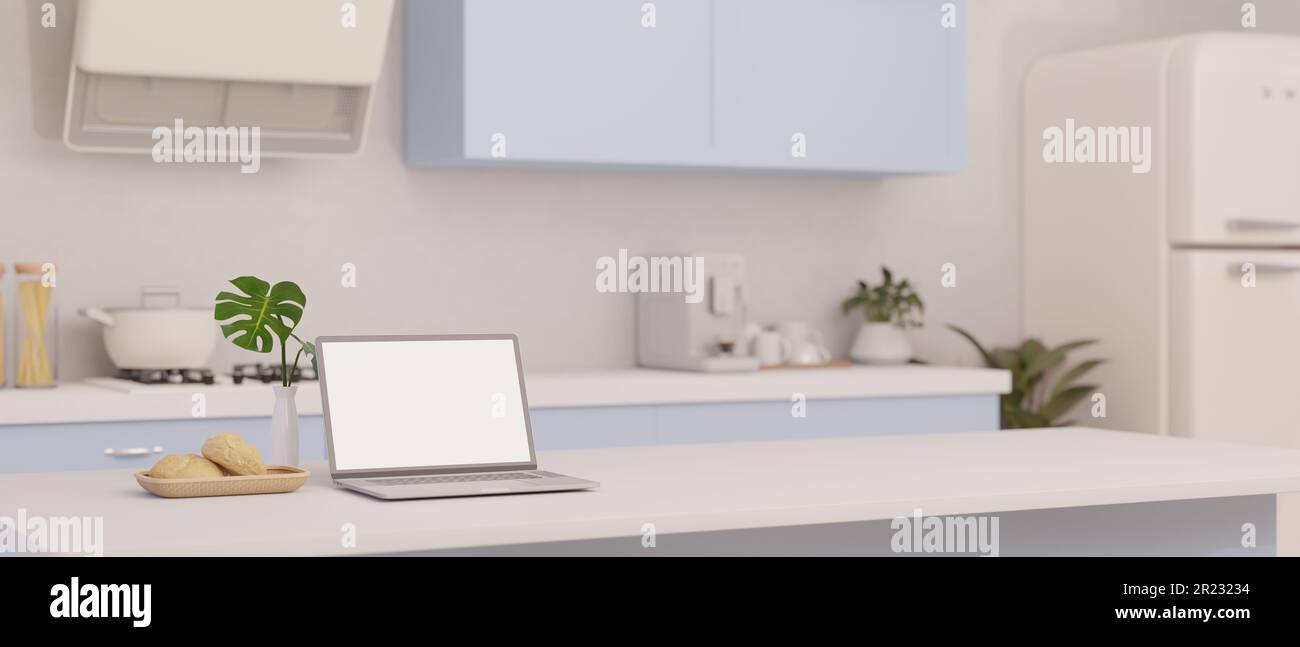 A laptop computer white screen mockup on a white kitchen island in ...