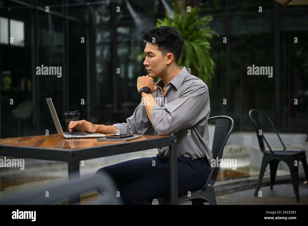 Professional using computer outdoor hi-res stock photography and images ...
