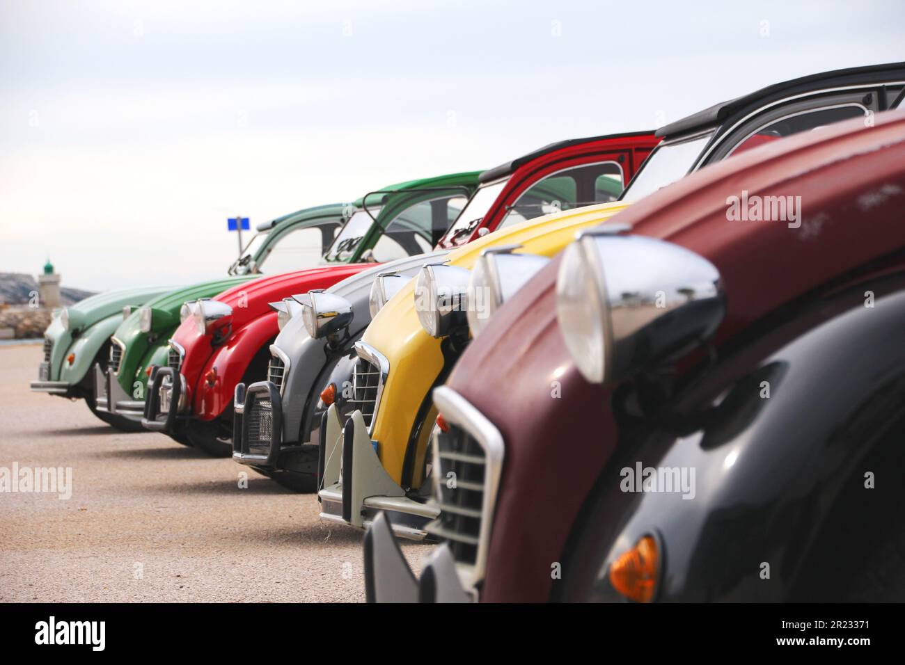 Side image of various classic and vintage cars of different colors ...