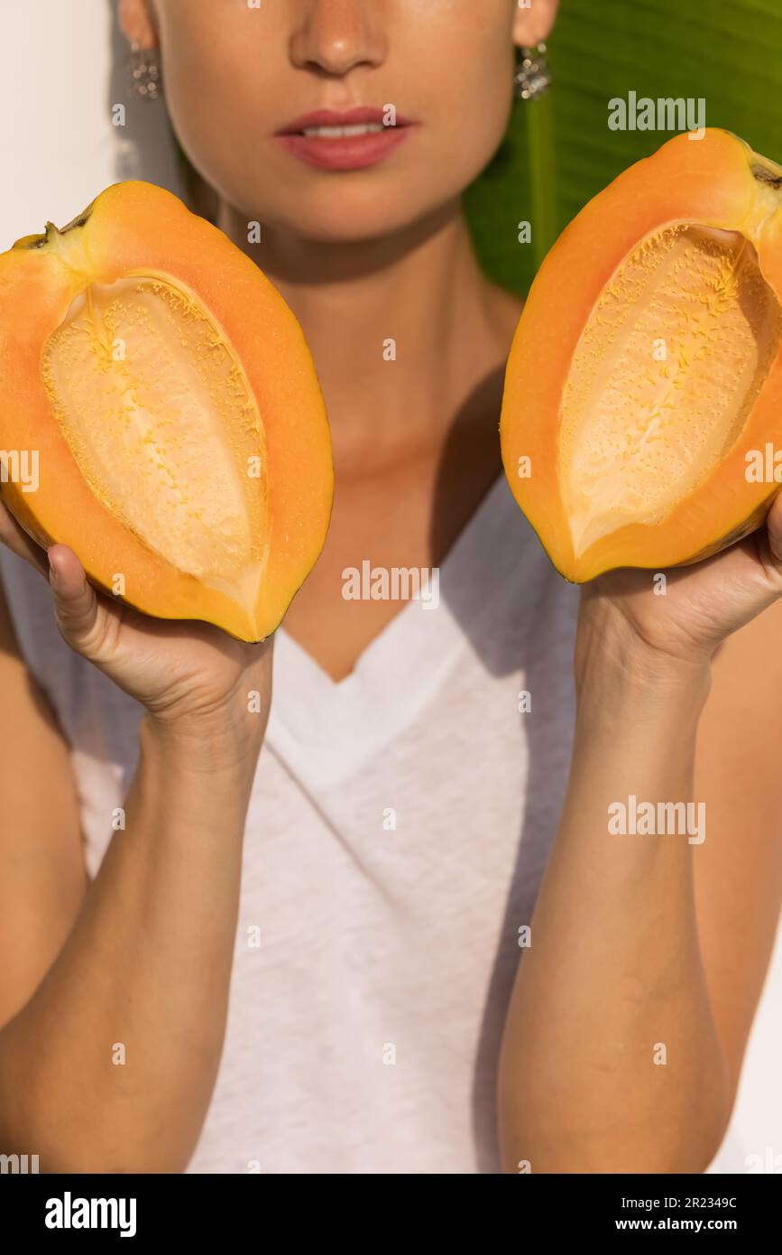 two Half of papaya fruit on banana leaves. Fragrant tropical fruit pulp ...