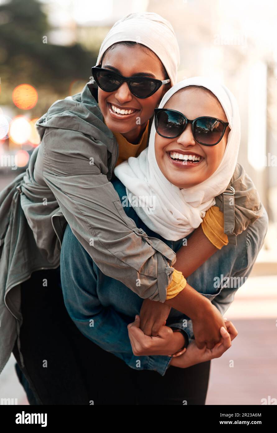 Islamic woman, friends and piggyback in city with freedom, youth and ...
