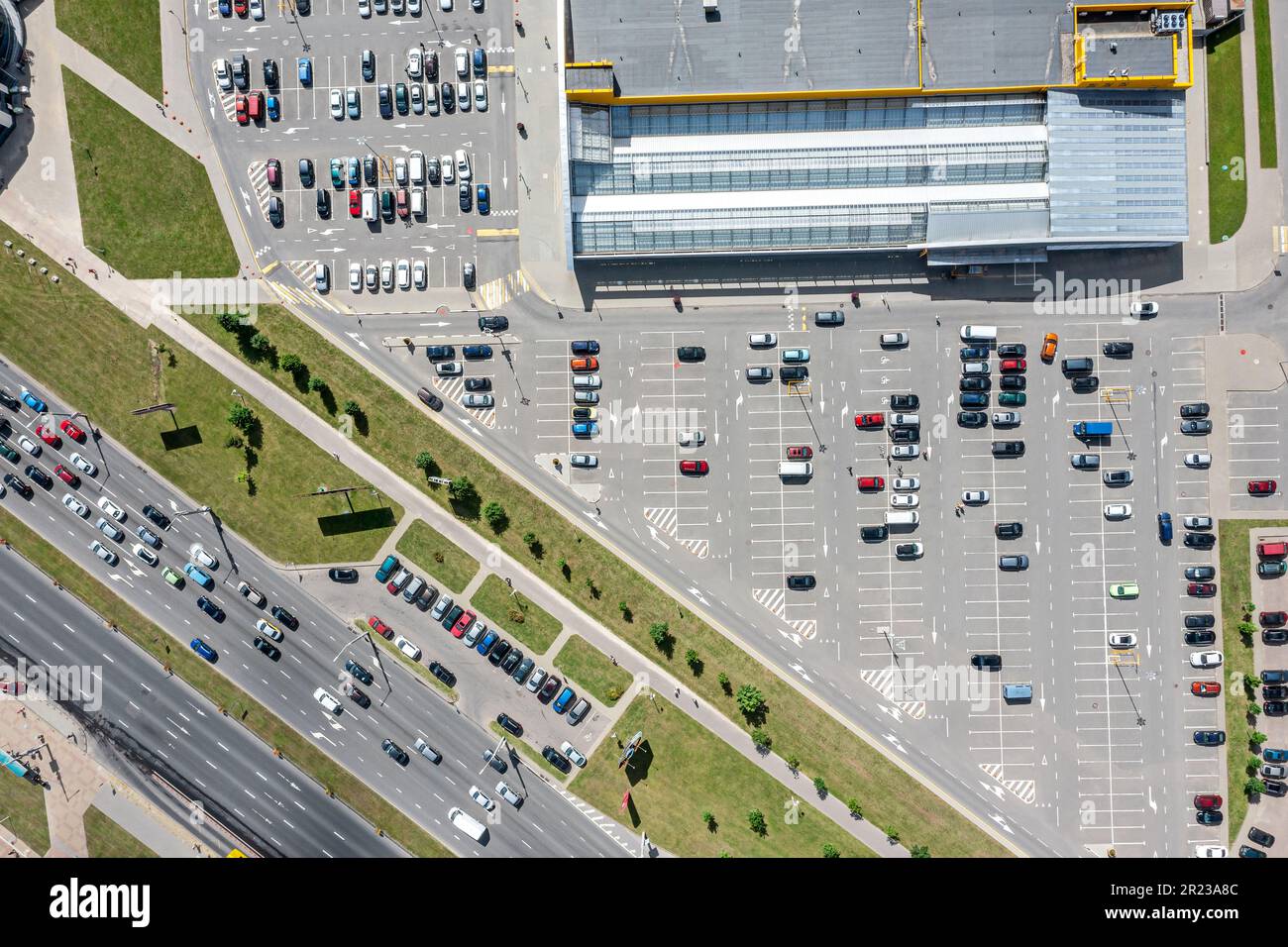 aerial top view of shopping mall parking lot with parked cars and city ...