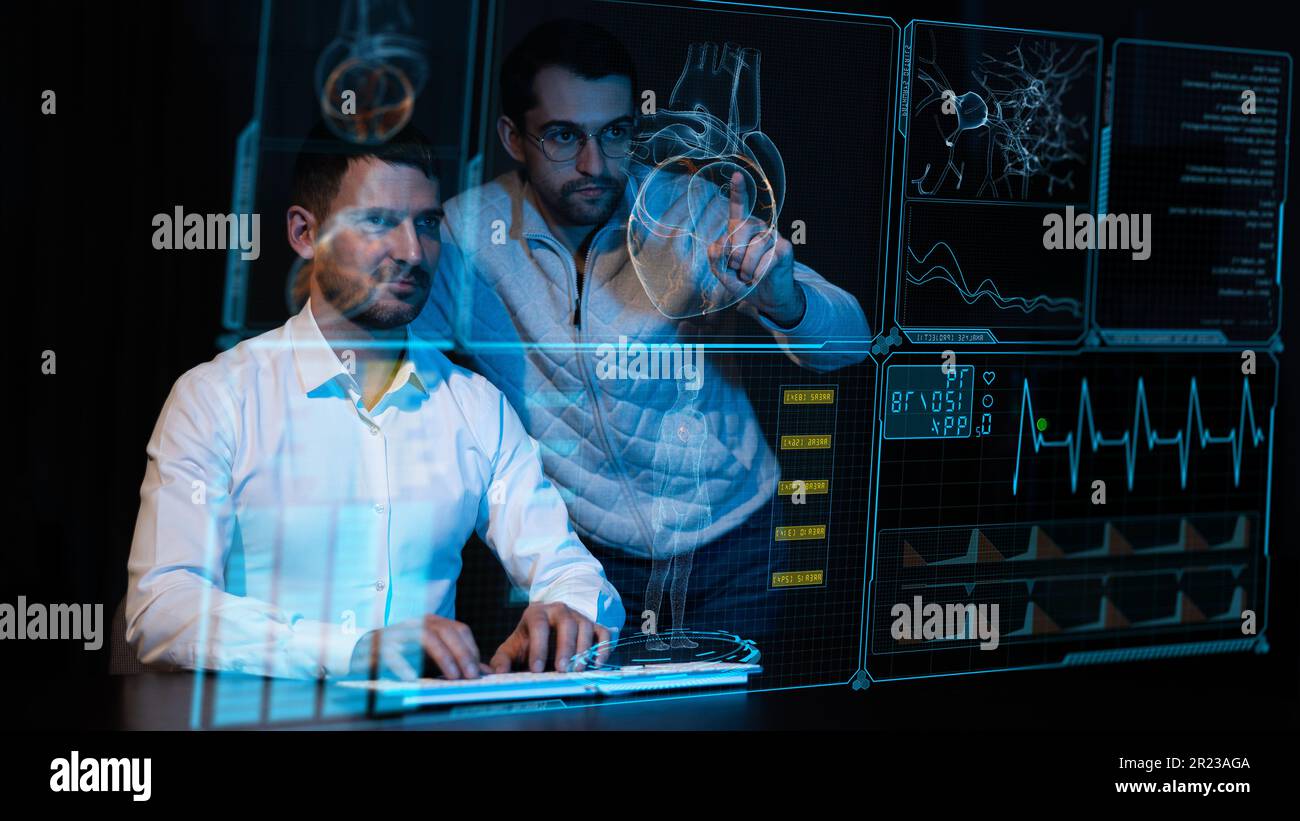 Two caucasian bearded men are looking and discussing the data on the ...