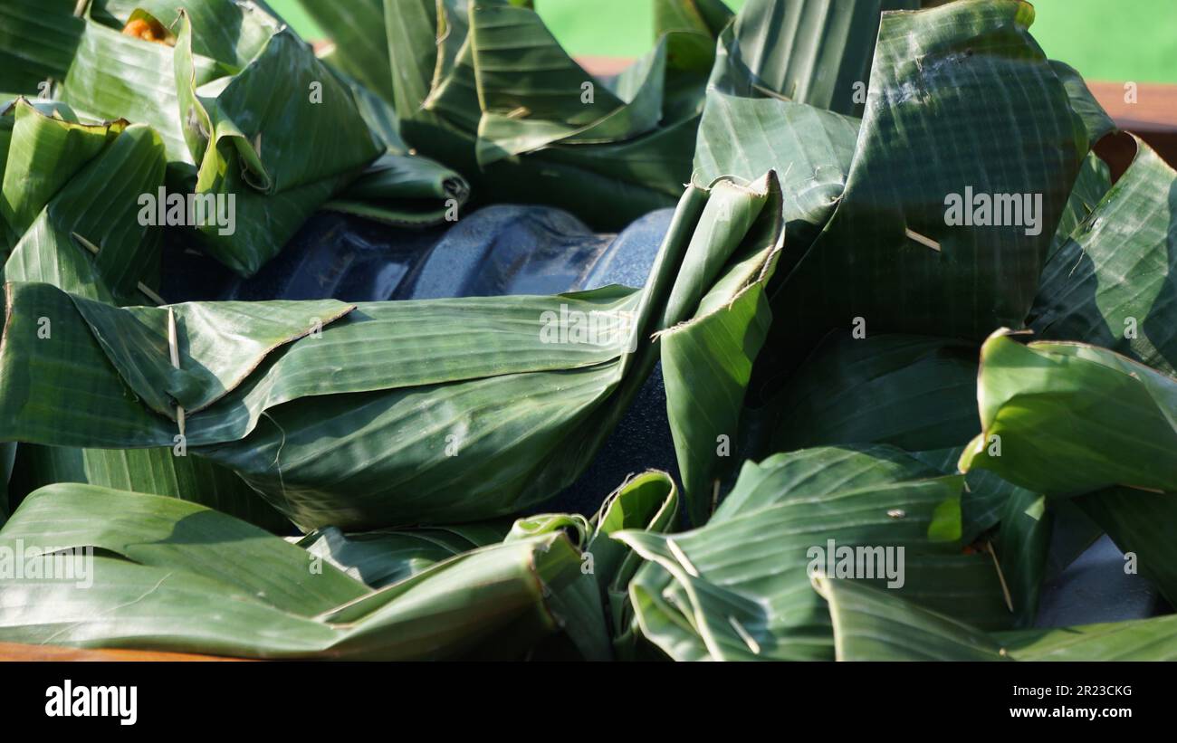 Nasi bungkus (rice wrapped with banana leaves) on the basket. Nasi ...